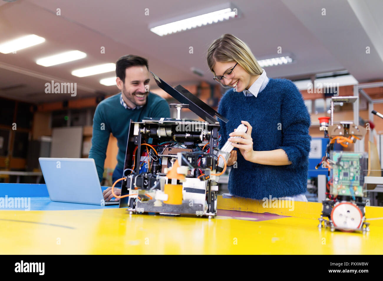 Young attractive students of mechatronics working on project Stock ...