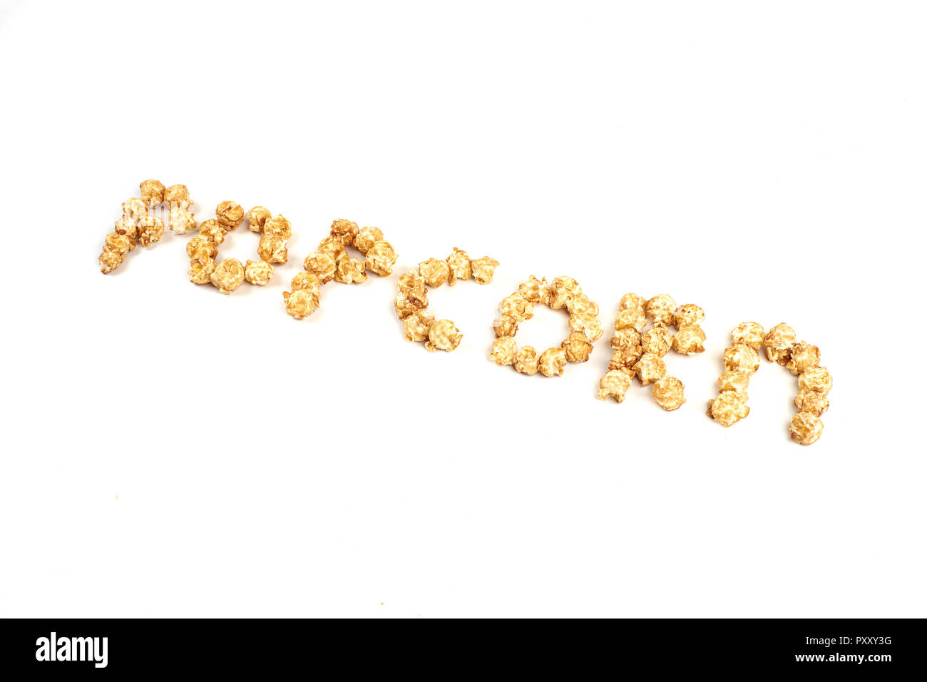 The word POPKORN is laid out from pieces of caramel popcorn on a white ...