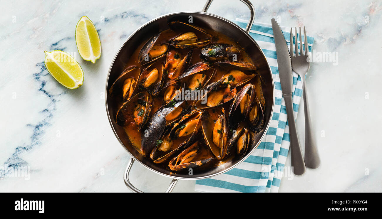 banner of freshly cooked mussels in a frying pan in tomato sauce ...