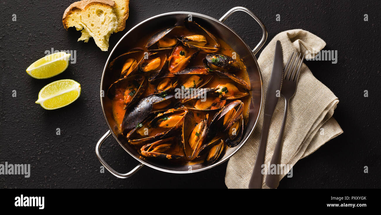 banner of freshly cooked mussels in a frying pan in tomato sauce ...