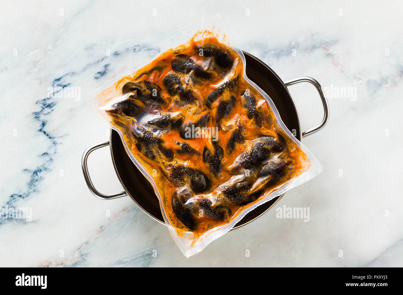 Frozen mussels in a package on a blue marble table in a skillet Stock ...