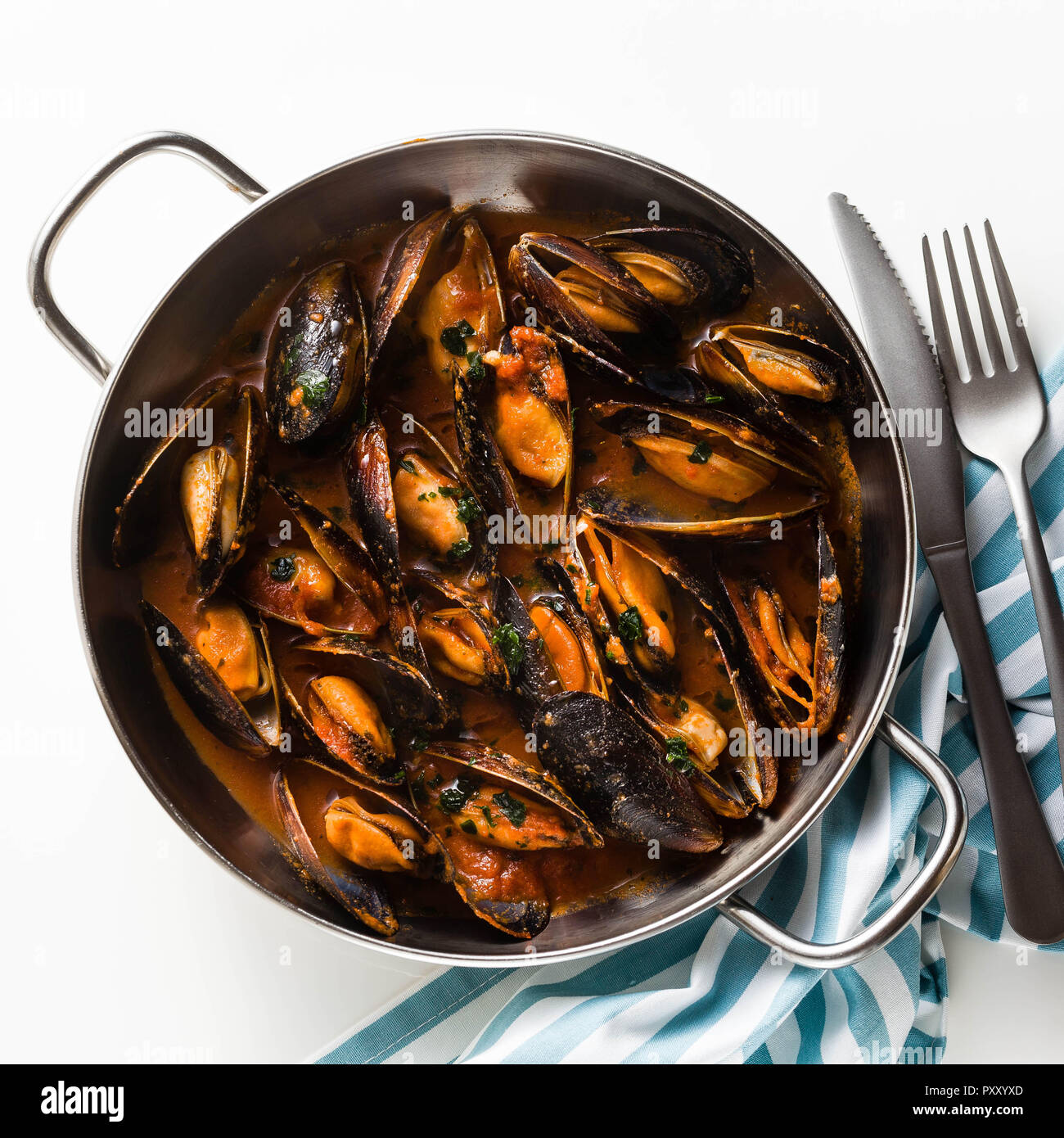 freshly cooked mussels in a frying pan in tomato sauce. pepata di cozze ...