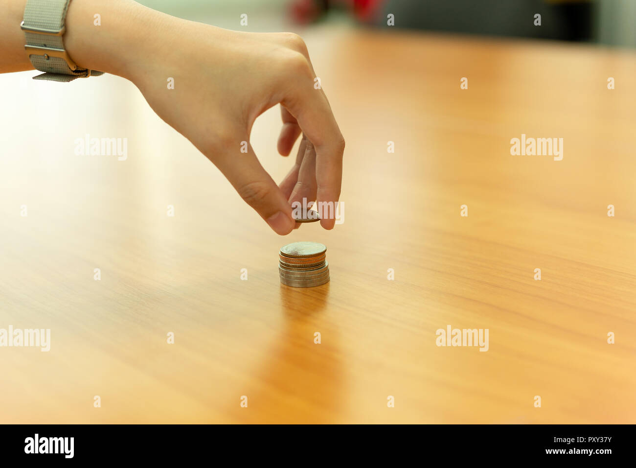 Hand putting coin on coins stack with Savings, Finance concept Stock ...