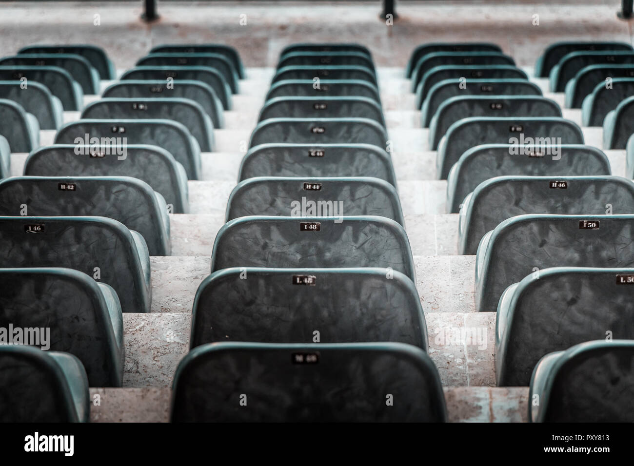 Free unclaimed seats in multiple rows. Sunset photo in empty public ...