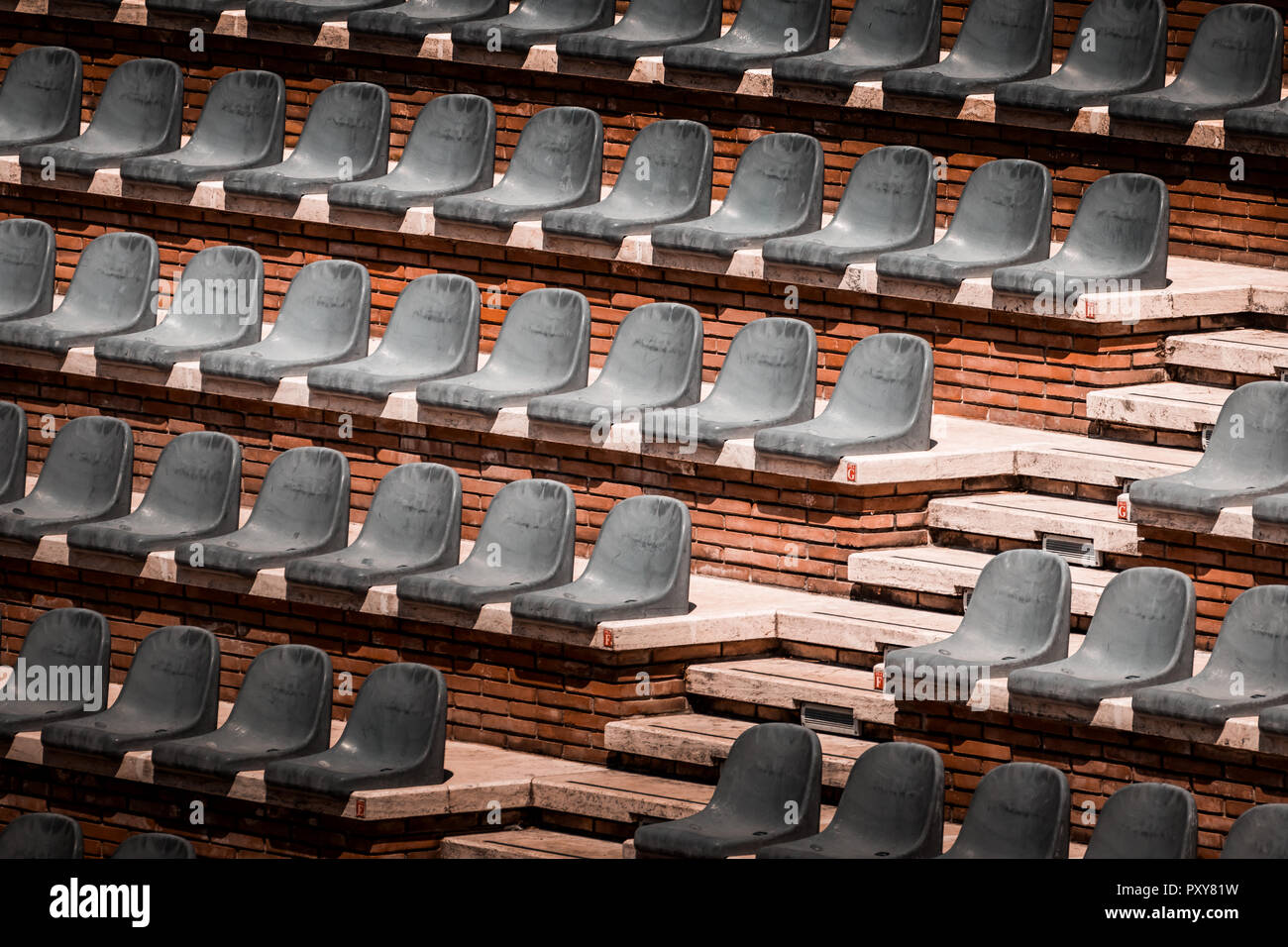 Free unclaimed seats in multiple rows. Sunset photo in empty public ...