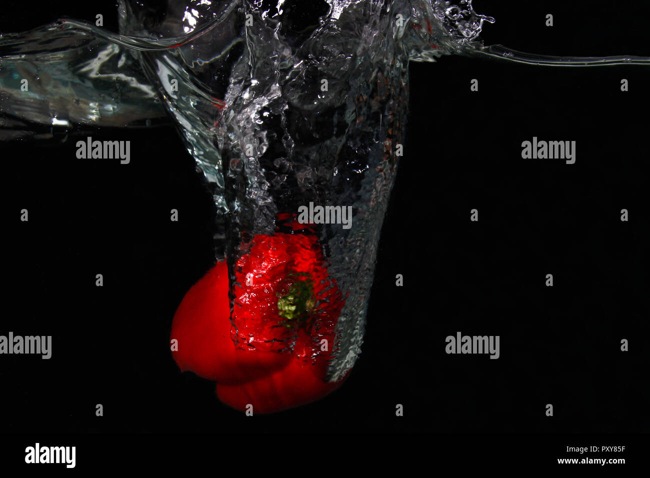 Ball pepper Splashes into water Stock Photo - Alamy