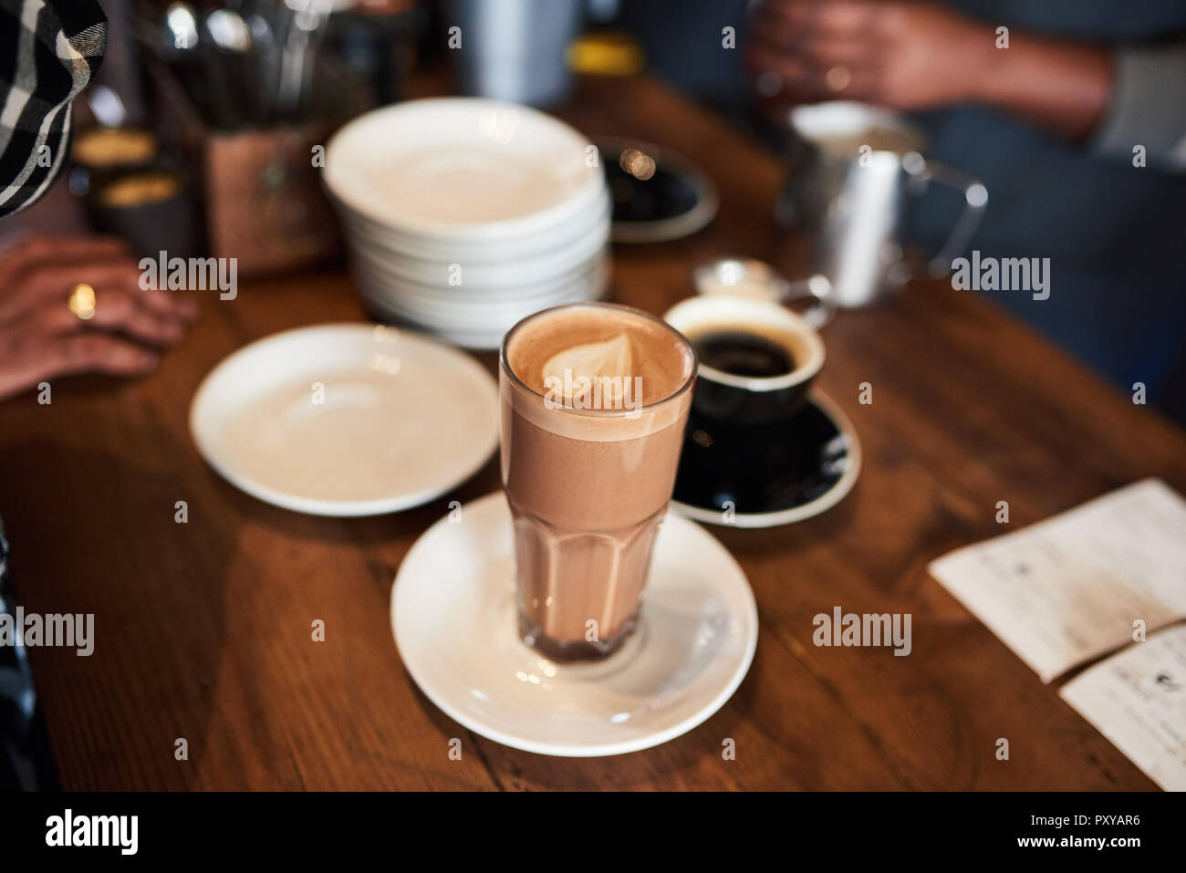 Customer collecting her drinks order at a cafe counter Stock Photo - Alamy