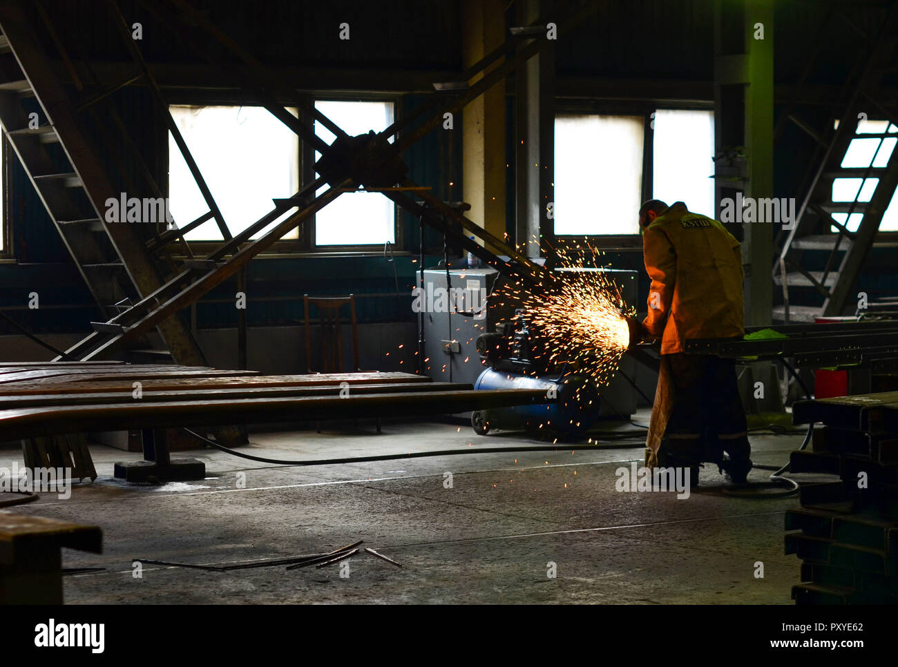 Industrial Worker labourer at the factory welding steel structure ...