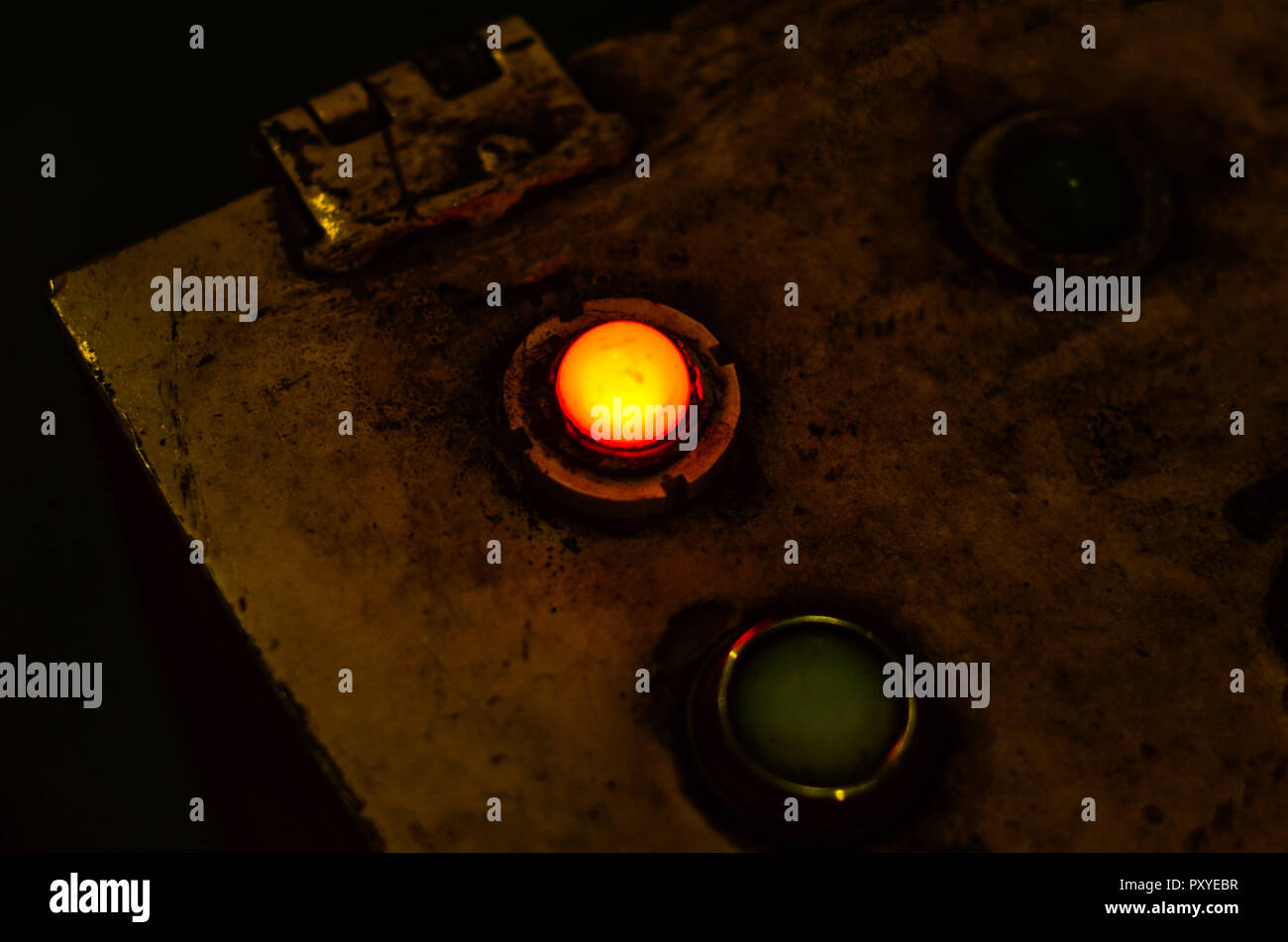 The shining red button of the electric control panel of the industrial ...