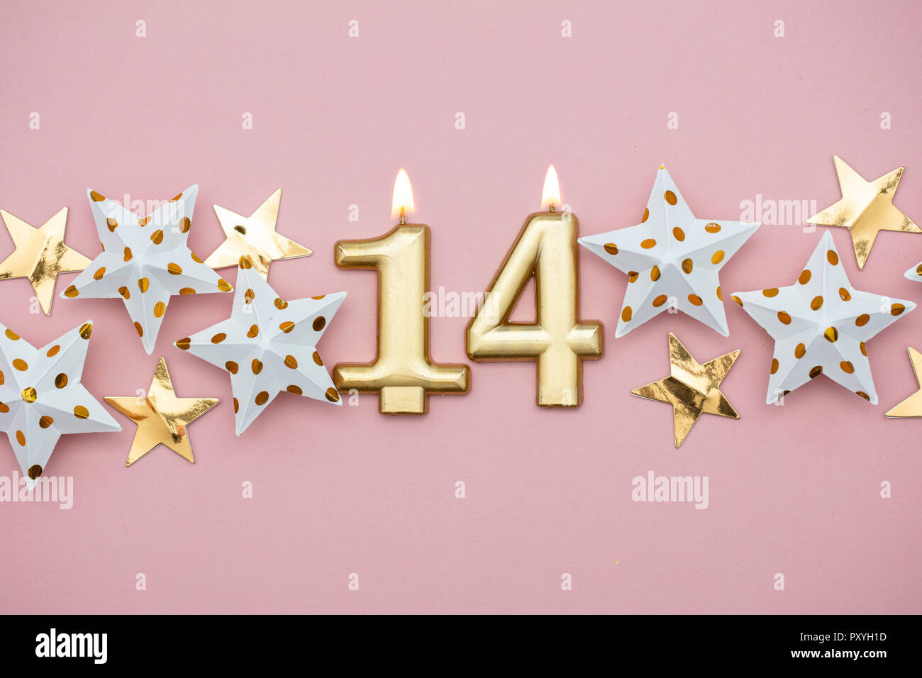 Number 14 gold candle and stars on a pastel pink background Stock Photo ...
