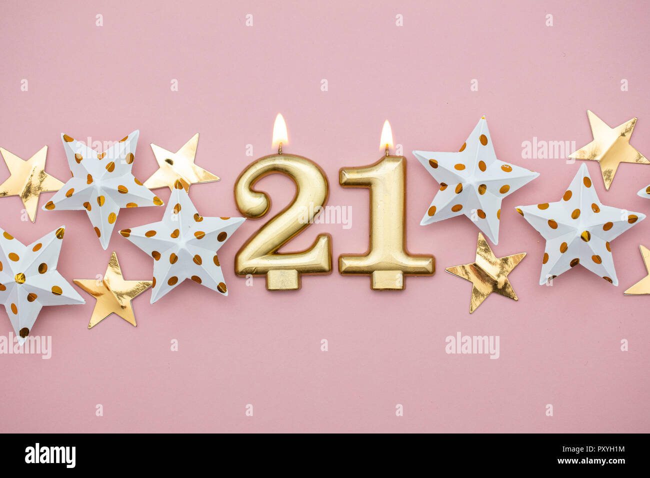Number 21 gold candle and stars on a pastel pink background Stock Photo ...