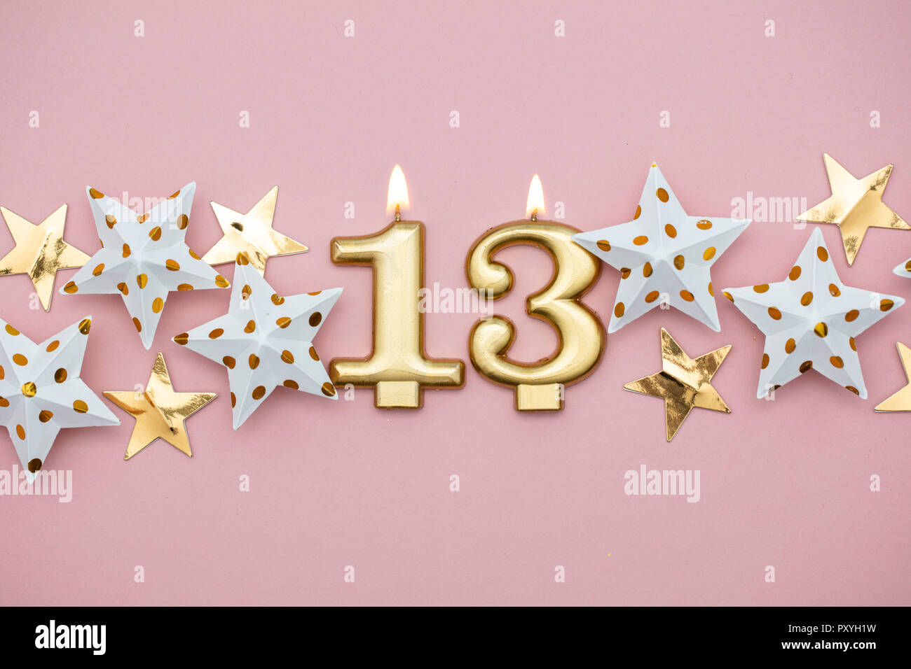 Number 13 gold candle and stars on a pastel pink background Stock Photo ...