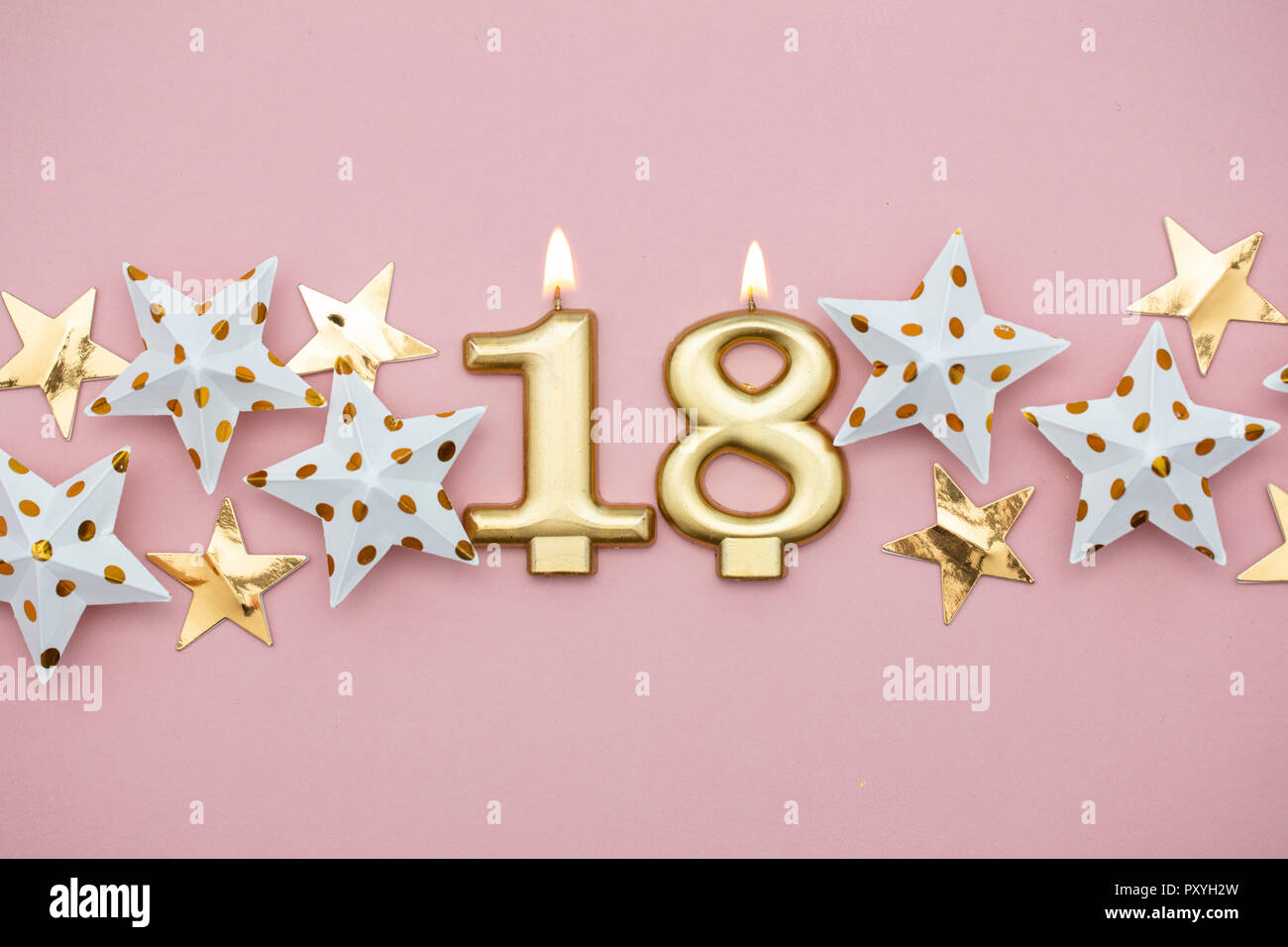 Number 18 gold candle and stars on a pastel pink background Stock Photo ...