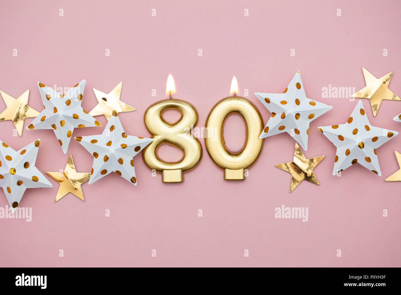 Number 80 gold candle and stars on a pastel pink background Stock Photo ...