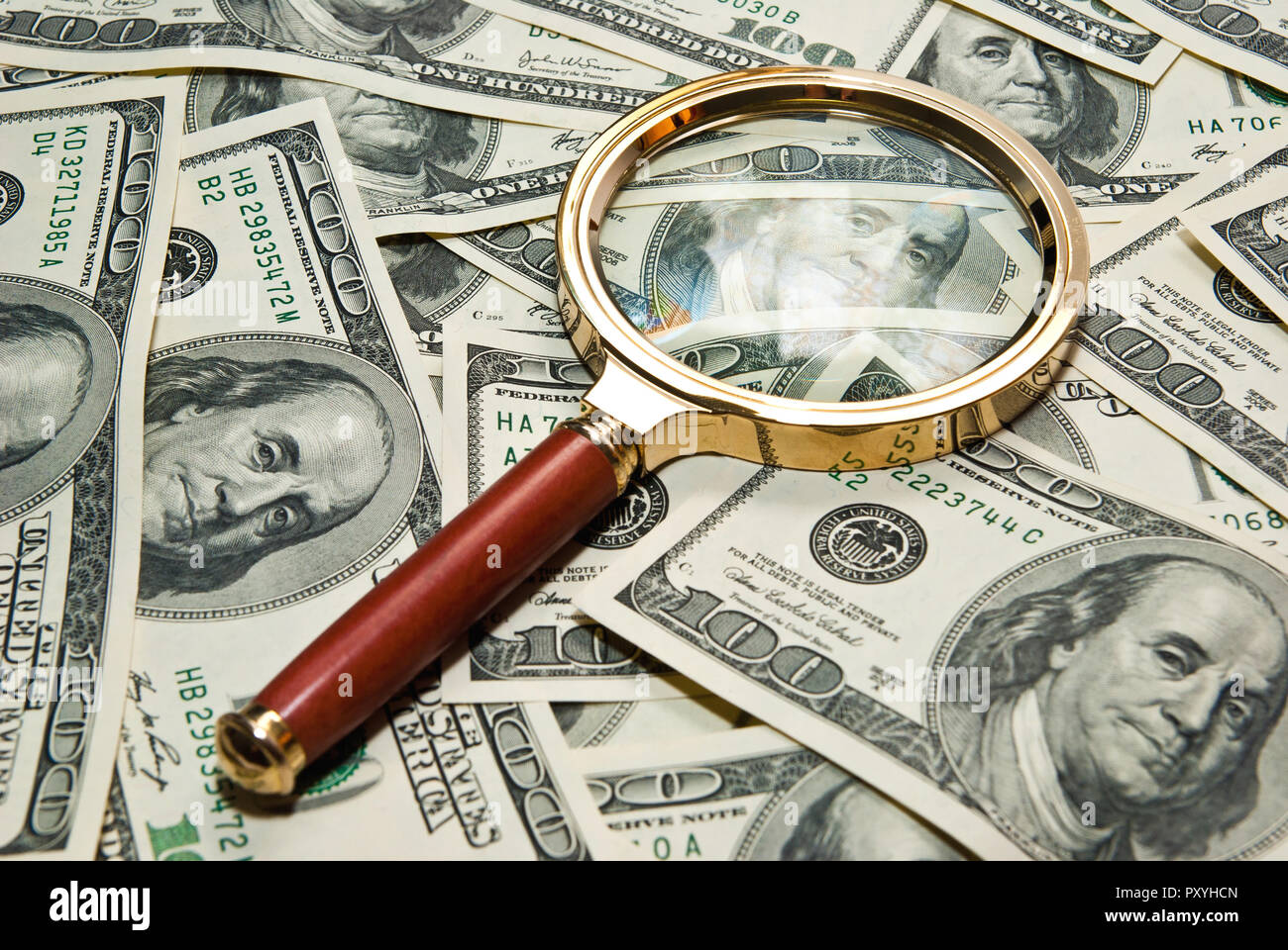 magnifying glass on a dollar background Stock Photo - Alamy