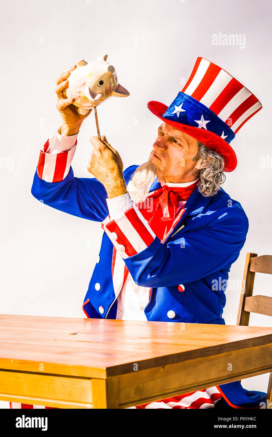 An Uncle Sam character holding up a piggy bank and attempting to pry ...