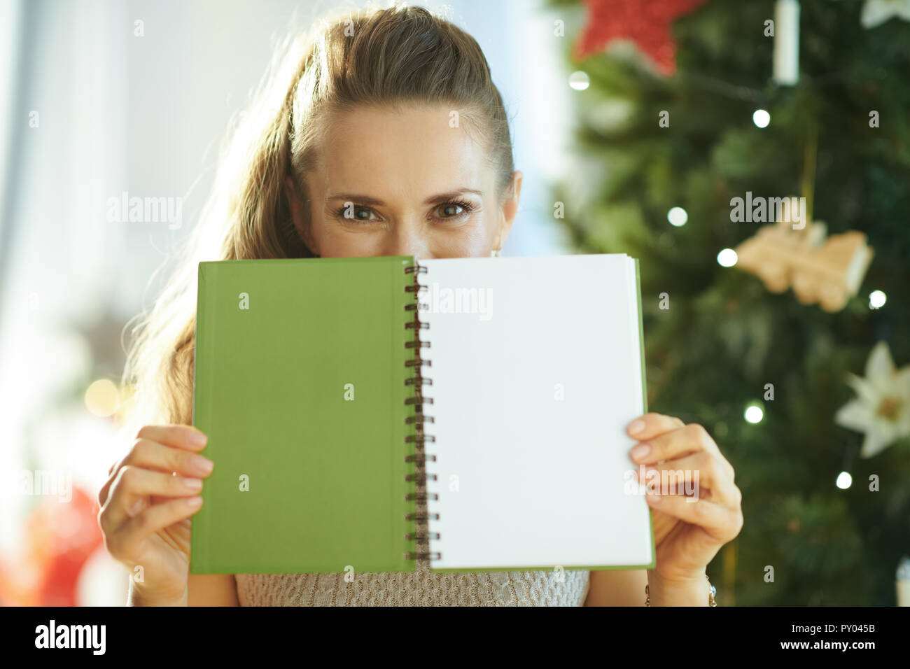 Hiding behind notebook hi-res stock photography and images - Alamy