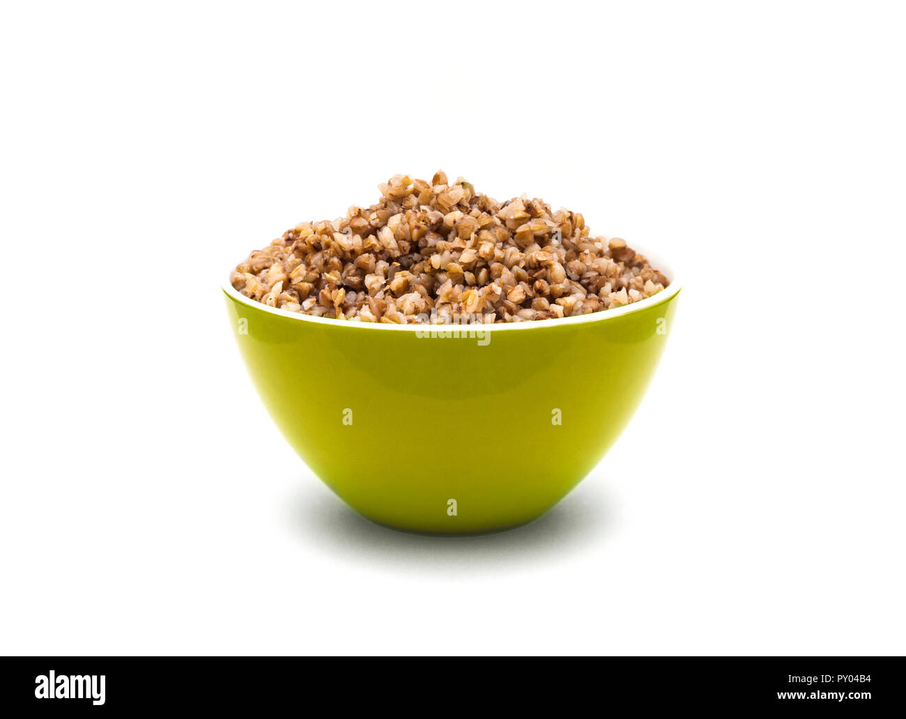Dry buckwheat in yellow color ceramic bowl isolated on white background ...