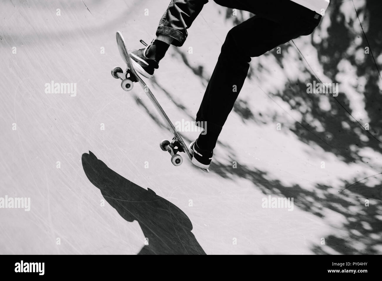 Crop skater doing ollie Stock Photo - Alamy