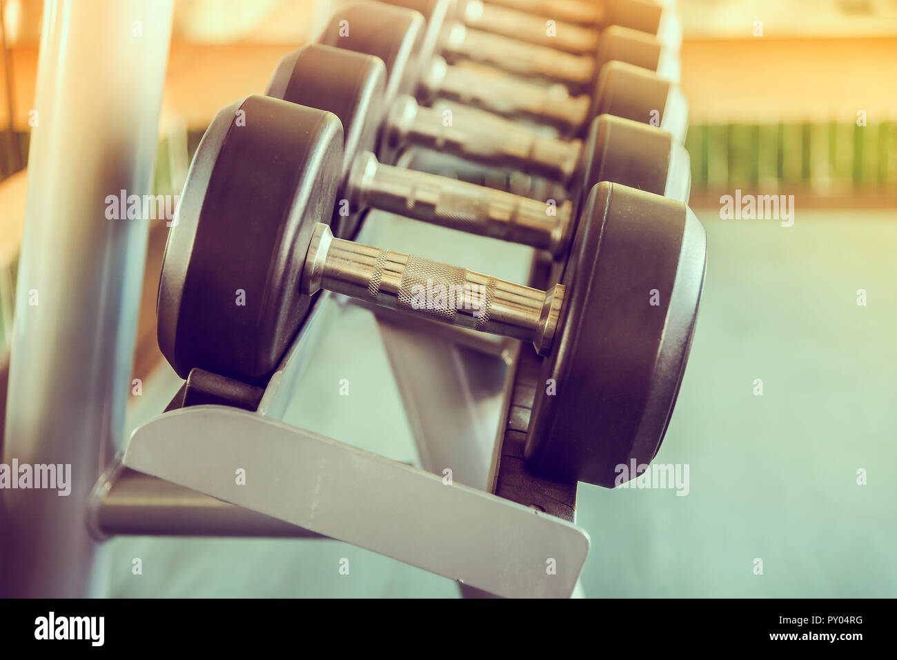 dumbbell in gym - vintage effect and sun flare filter effect Stock ...