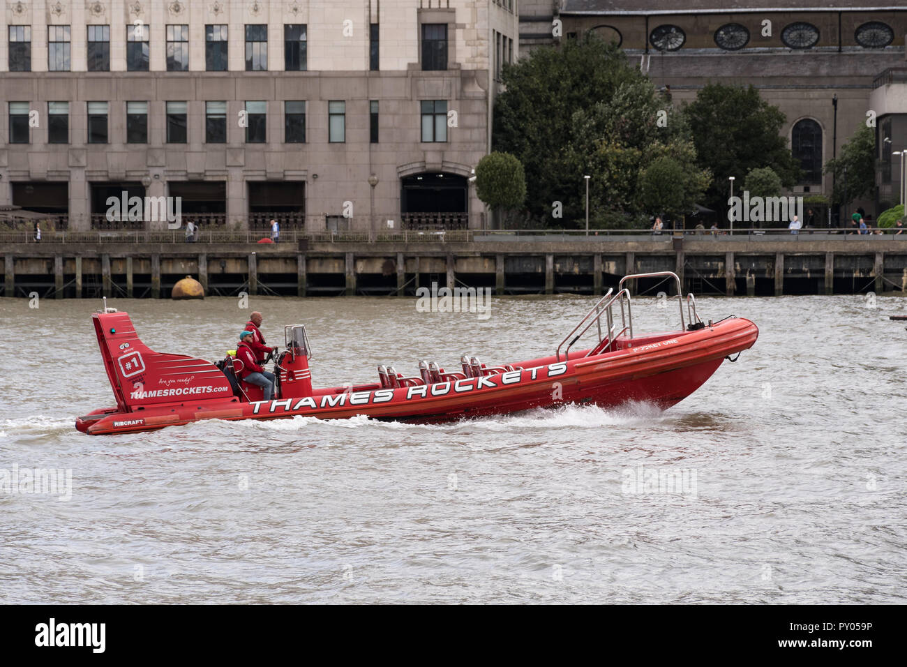A Thames Rocket RIB speedboat sails on the river Thames with two crew ...