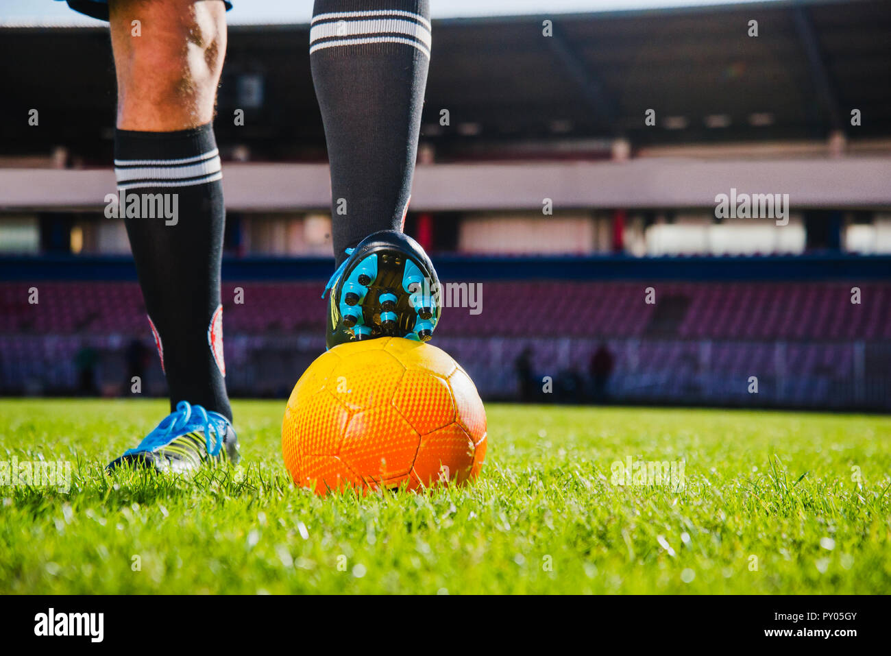 Football scene with ball and legs Stock Photo - Alamy