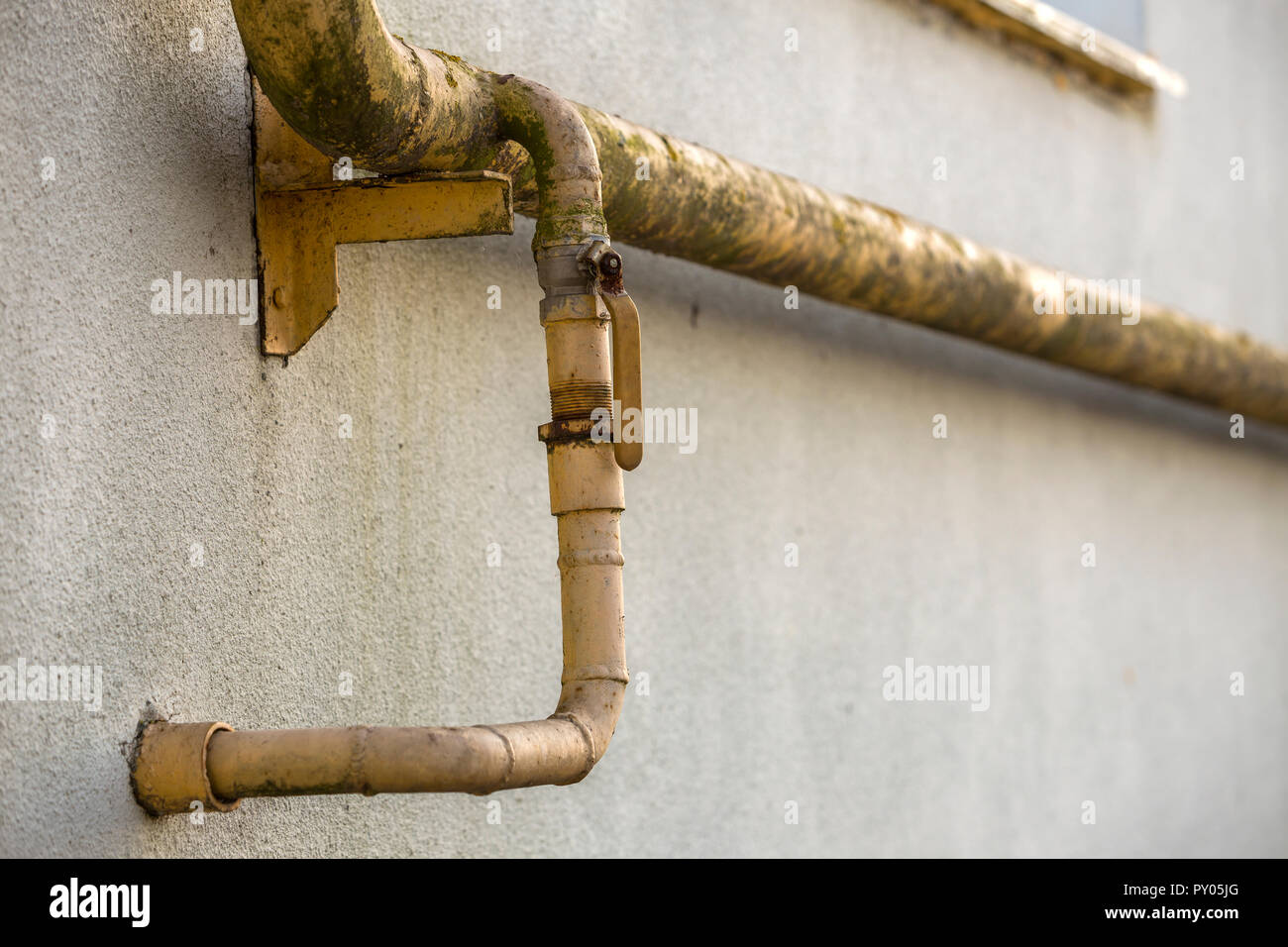 Close-up detail of old dirty painted yellow natural gas pipes with ...