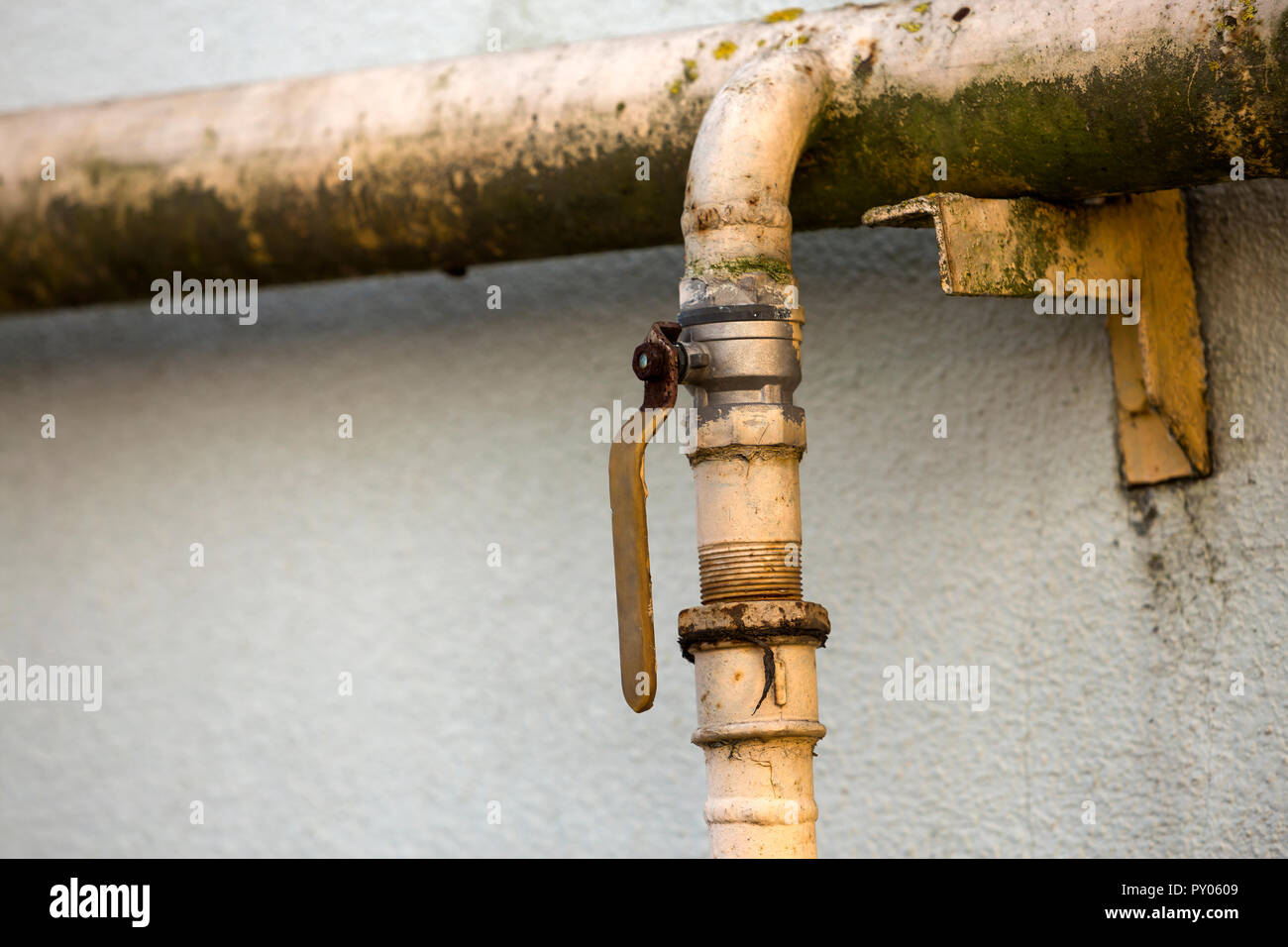 Close-up detail of old dirty painted yellow natural gas pipes with ...