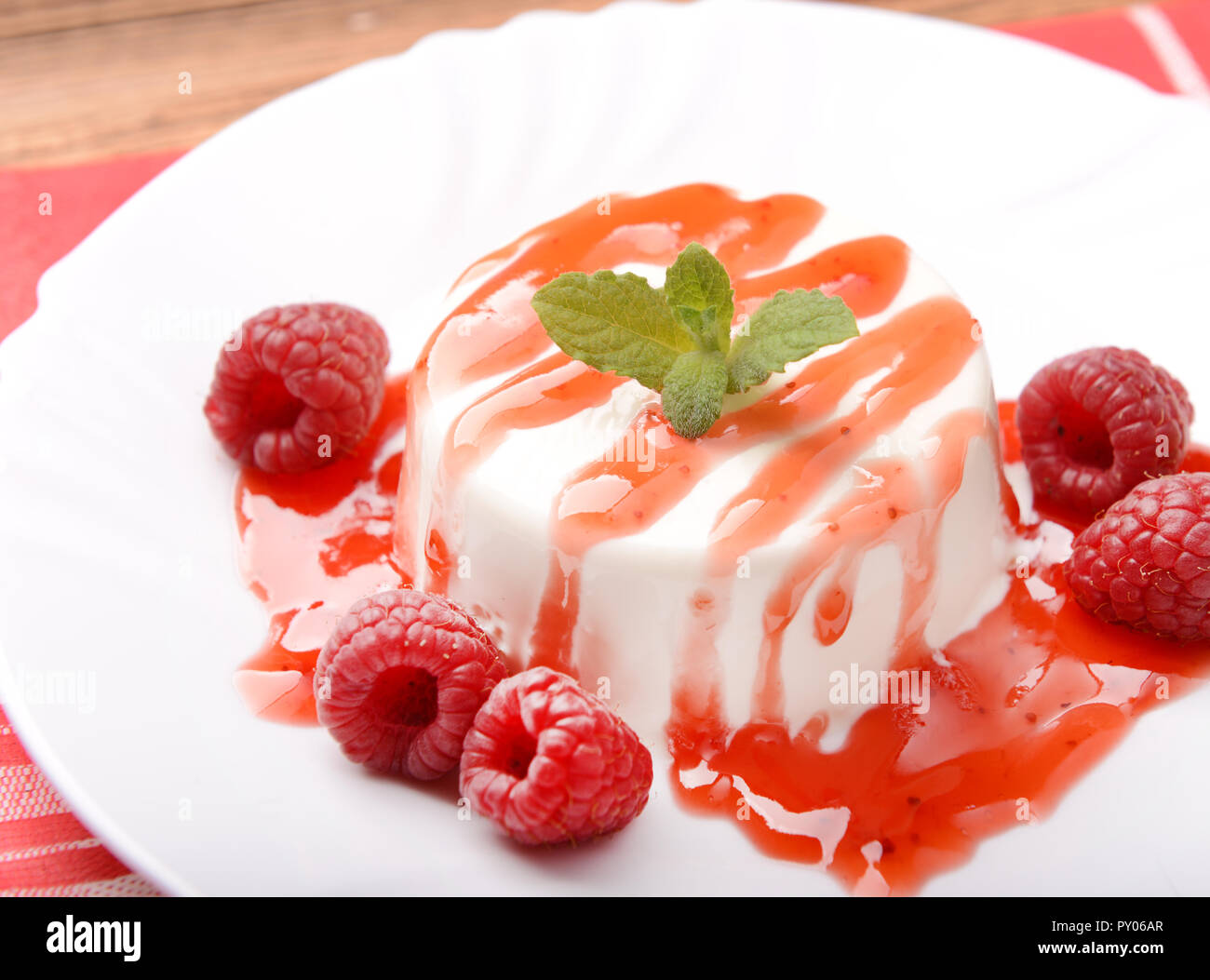 Italian dessert panna cotta with raspberries Stock Photo - Alamy