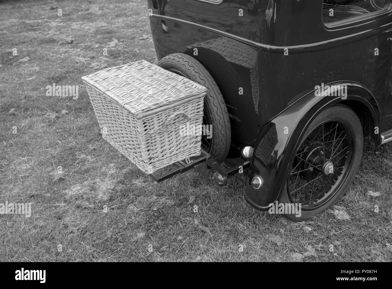 old luxury car with large mudguards and a basket on the back in black and white Stock Photo Alamy