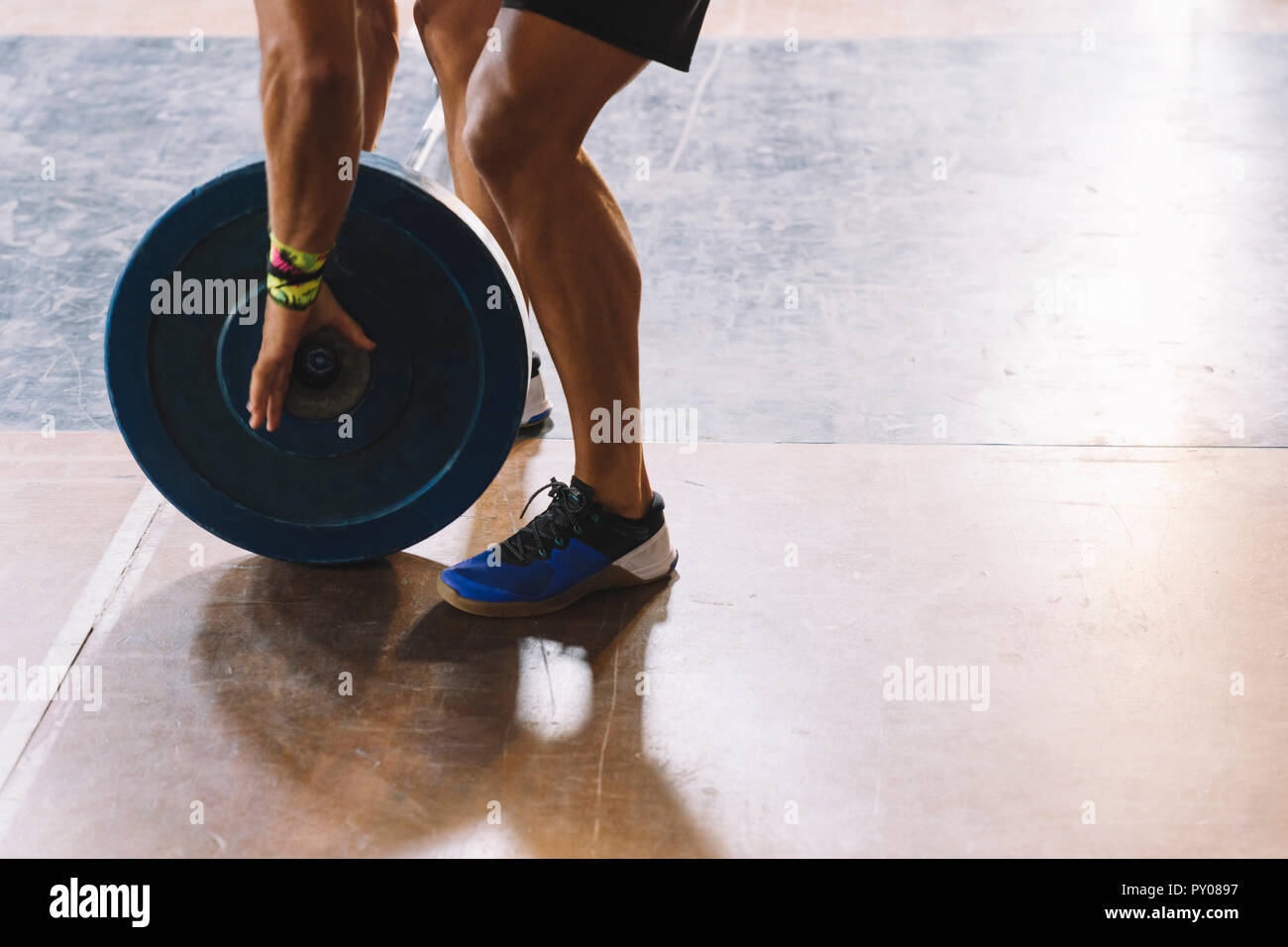 Man mounting barbell Stock Photo - Alamy