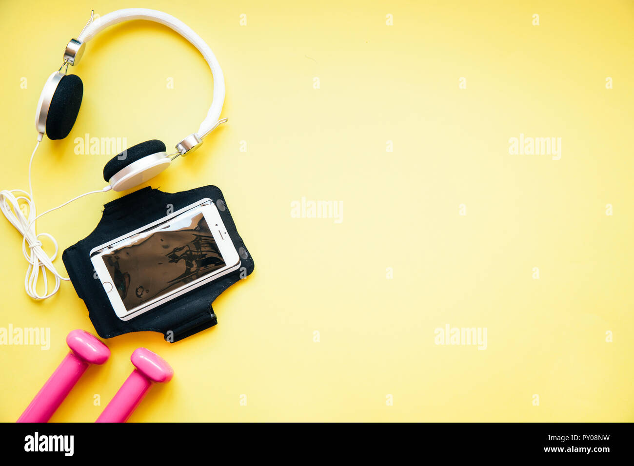 Smartphone with headphones and dumbbells Stock Photo - Alamy