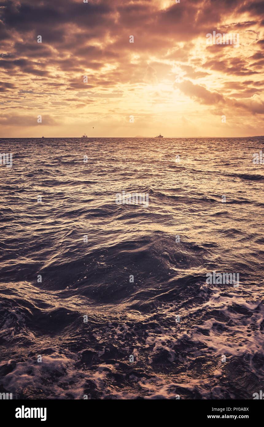 Scenic dramatic seascape with ships over the horizon at sunset, color ...