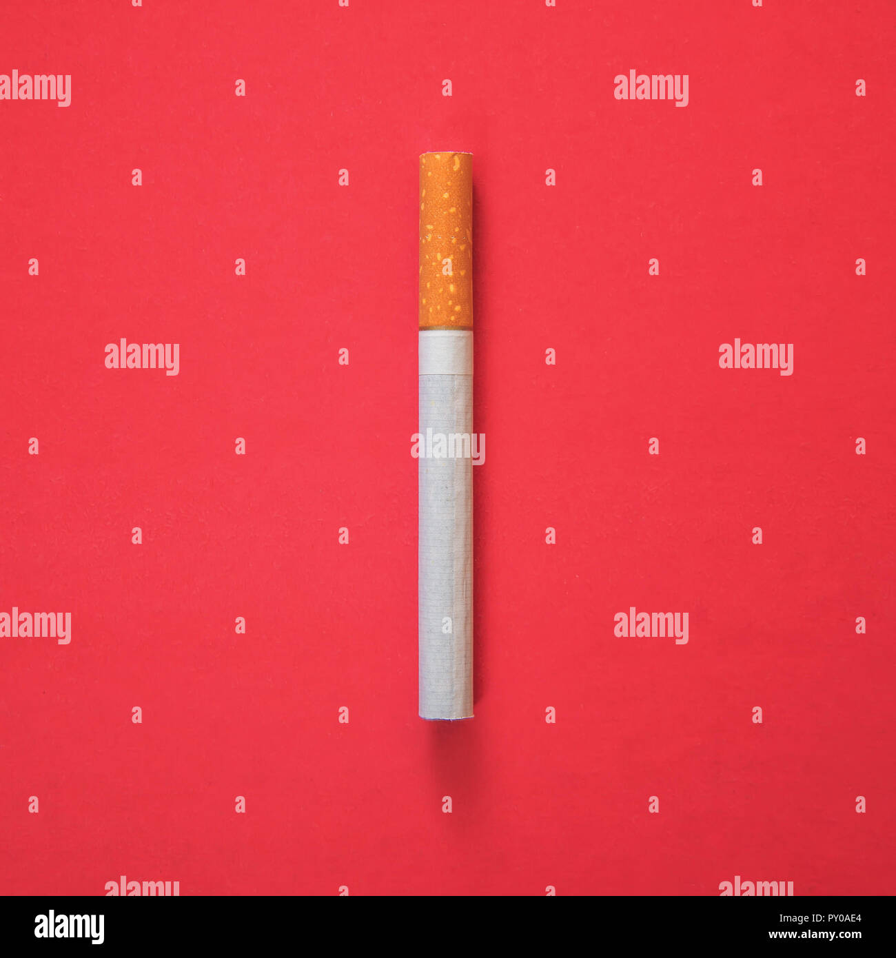 one cigarette on a red Stock Photo - Alamy