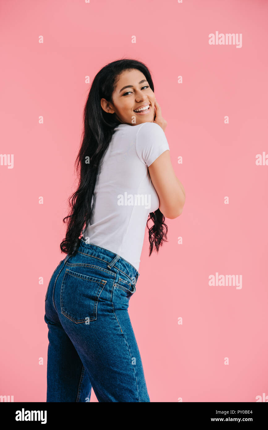 side view of happy african american woman posing isolated on pink Stock ...