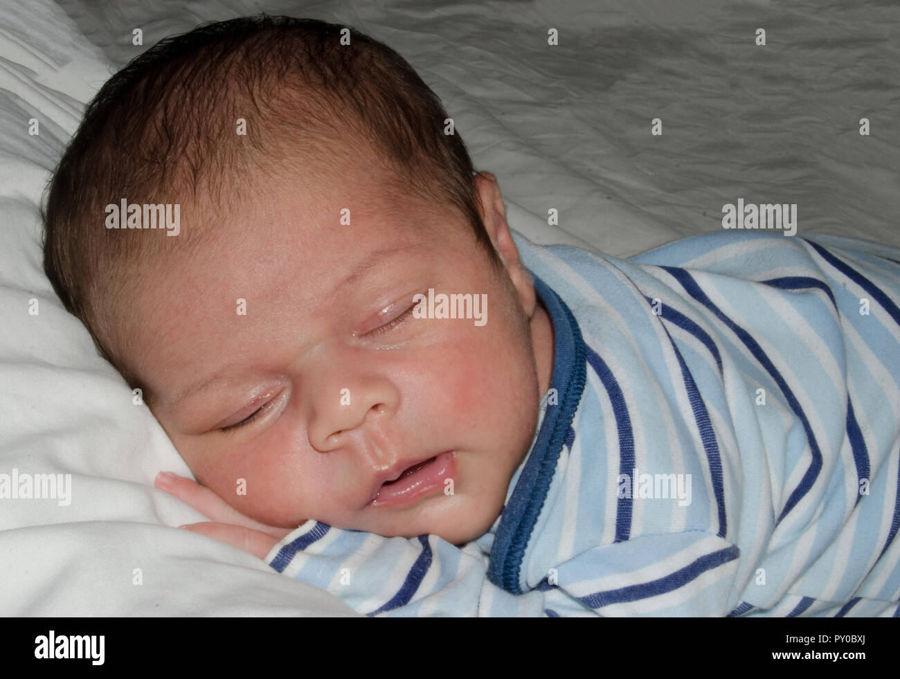 two weeks old newborn baby boy sleeping on white sheet, close up Stock ...