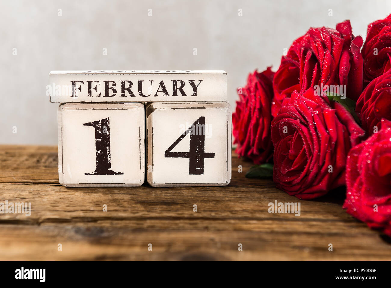Bunch of Red Roses for St Valentines Day with wooden block calendar and ...
