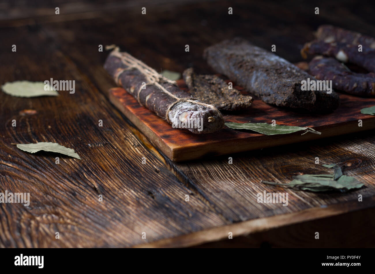 Home-made sausage on the kitchen board. Wooden table Stock Photo - Alamy