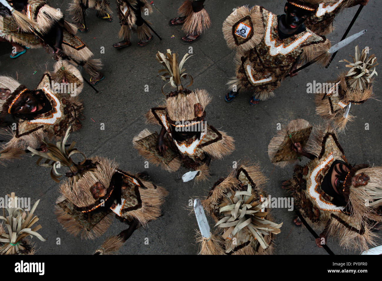 Children with black smeared faces in tribal costumes at Ati Atihan ...