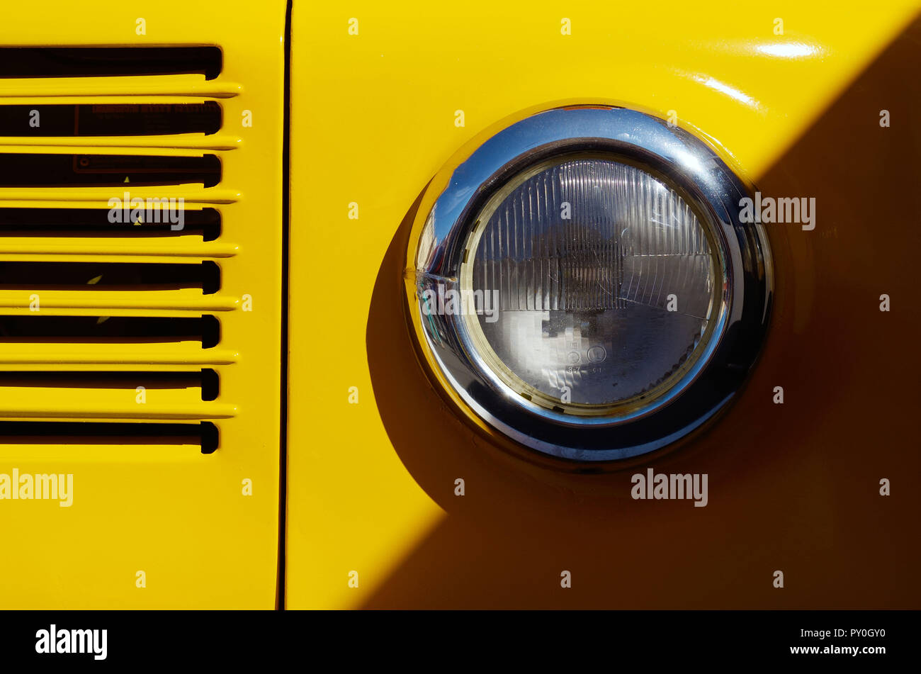Round headlight on the bus..In the dark, the headlight illuminates the ...