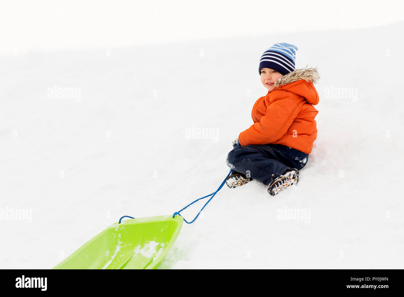 Boy on sled hi-res stock photography and images - Alamy
