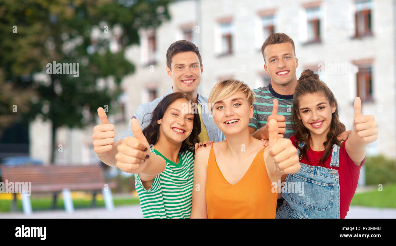 happy friends showing thumbs up Stock Photo - Alamy