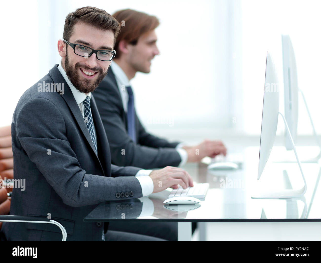 side view.businessman sitting at his Desk Stock Photo - Alamy