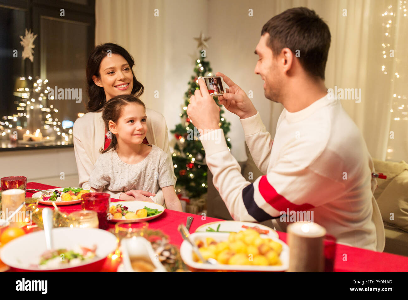 happy family taking picture at christmas dinner Stock Photo - Alamy