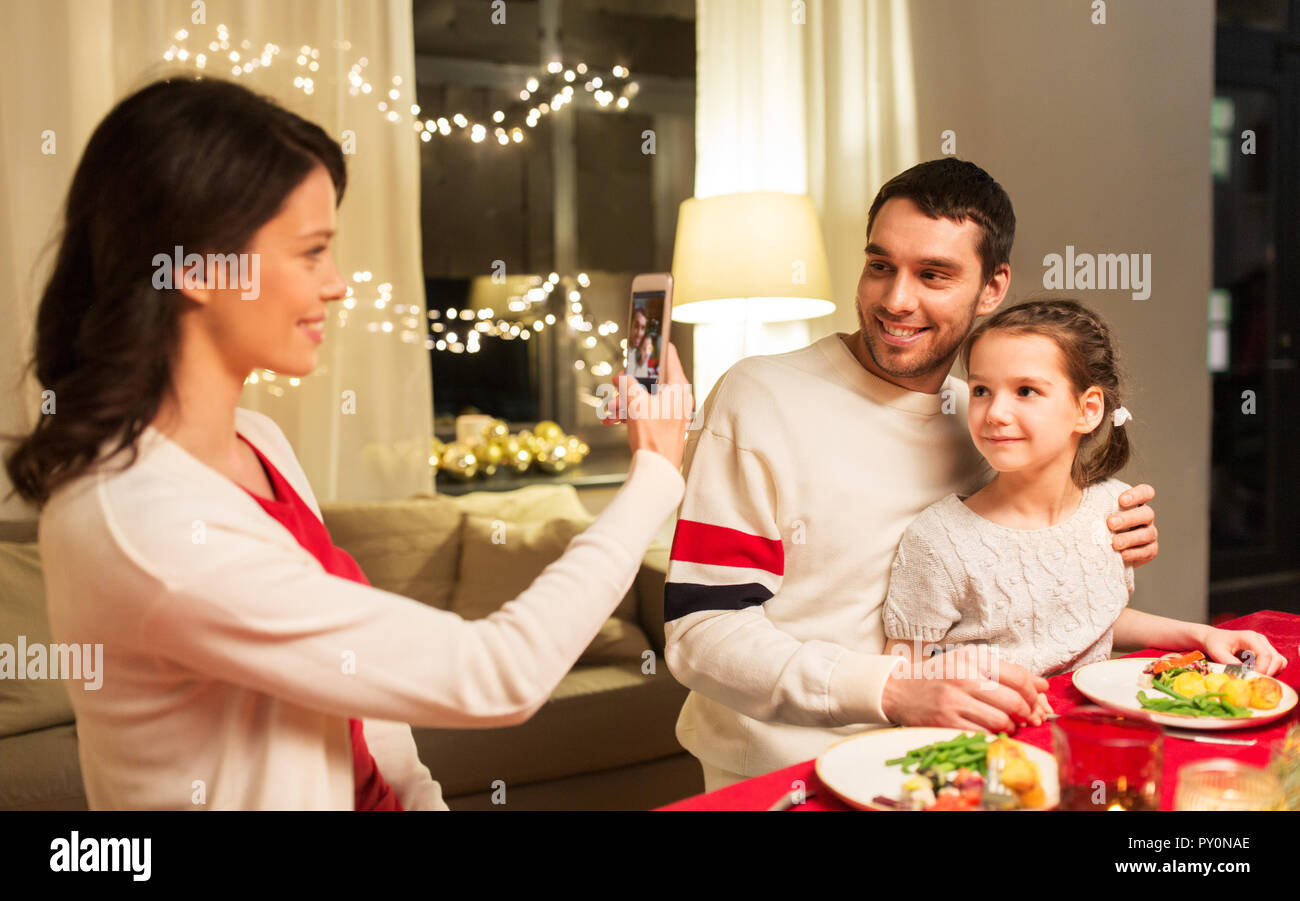 happy family taking picture at christmas dinner Stock Photo - Alamy