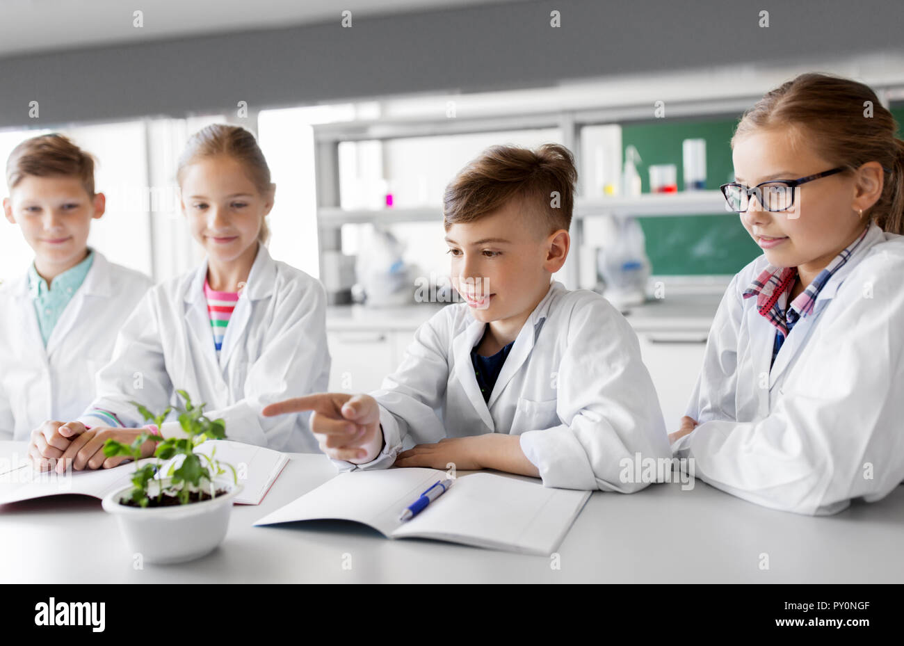 kids or students with plant at biology class Stock Photo - Alamy