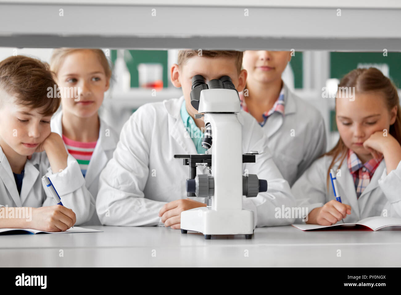 kids or students with microscope biology at school Stock Photo - Alamy