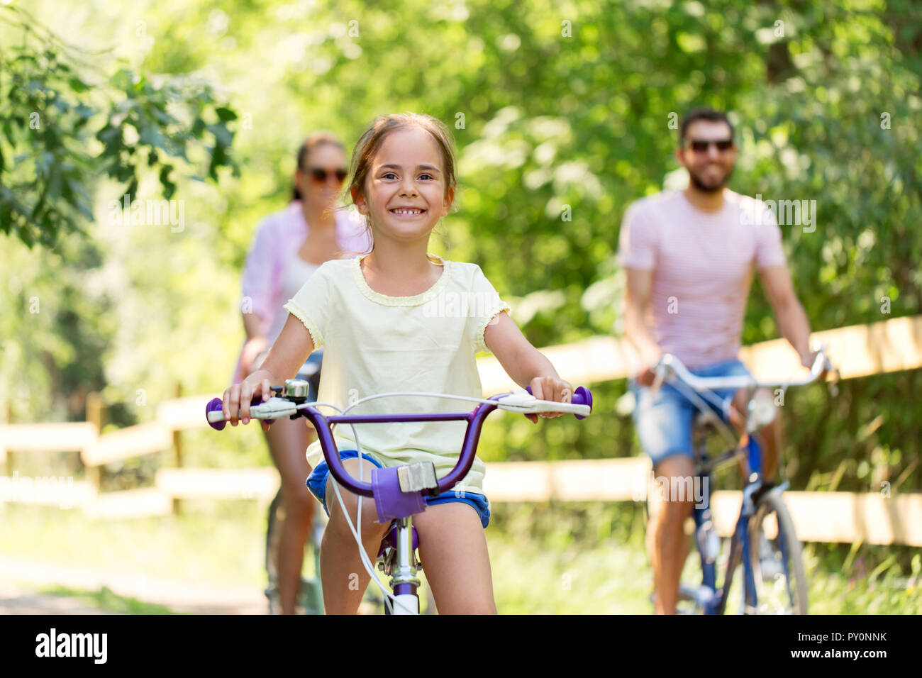 happy family riding bicycles in summer park Stock Photo - Alamy