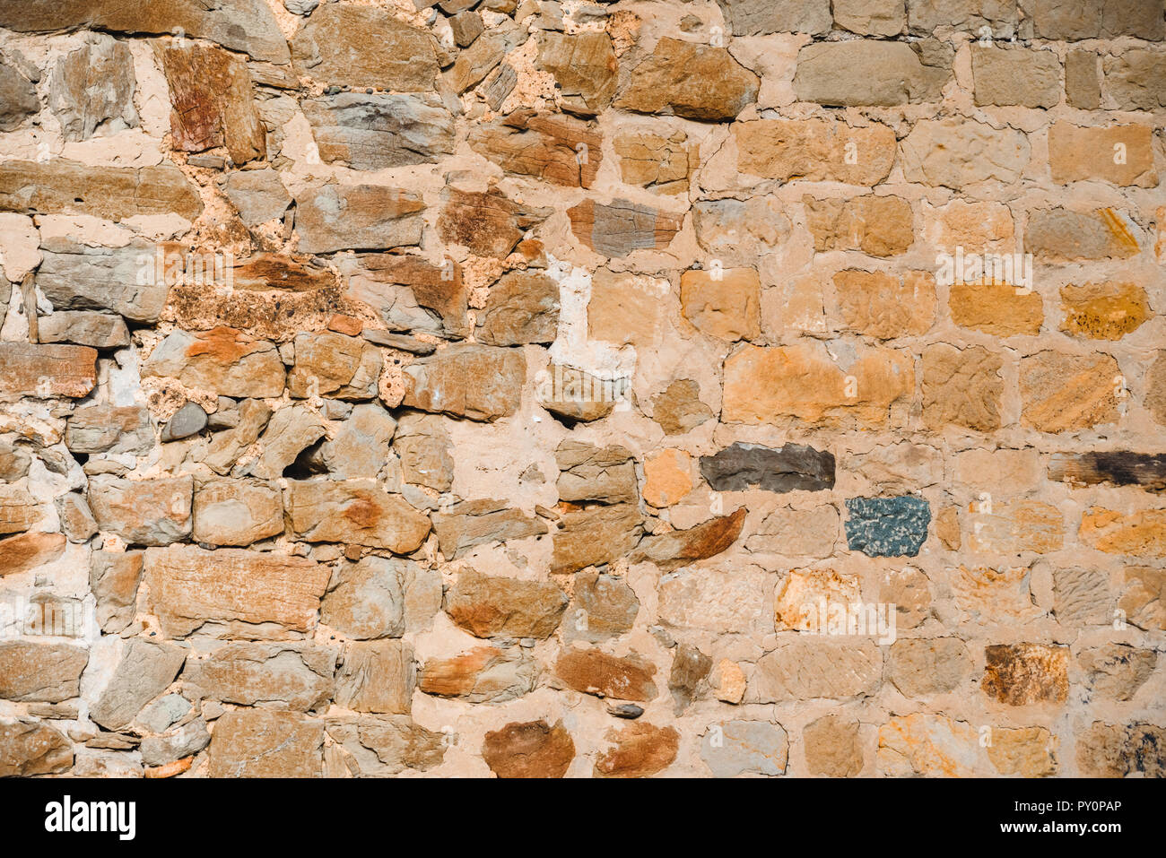 Ancient wall from big colourful brick square stones Stock Photo - Alamy