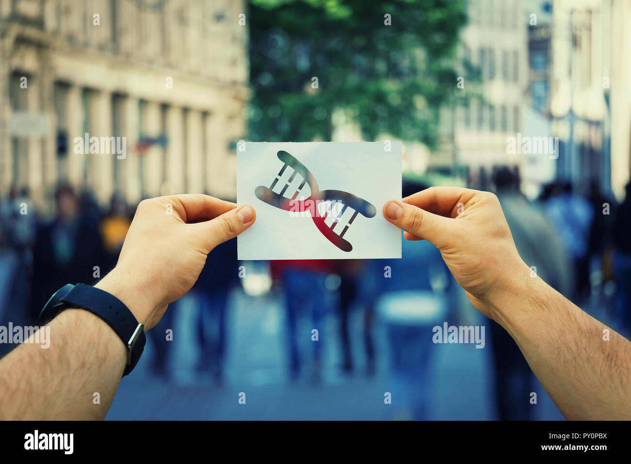 Close up of man hands holding a white paper sheet with dna cell symbol ...